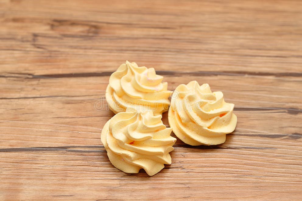 Three Yellow Meringues on a Table Stock Photo - Image of cake, meringue ...