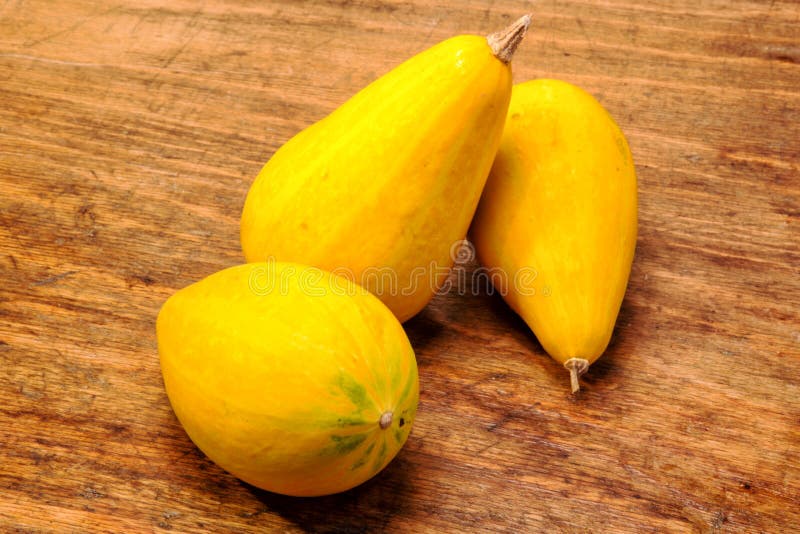 Three Yellow Squash on Rustic Wooden Table Stock Photo - Image of ...