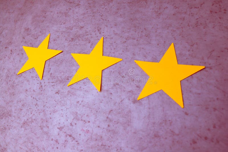 Three Yellow Stars on Purple Concrete Background. Negative Feedback ...