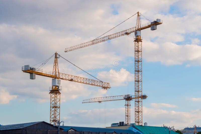 Three Yellow Tower Construction Cranes Against Cloudy Sky Stock Image ...