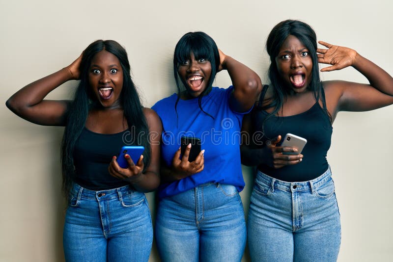 Three Young African American Friends Using Smartphone Crazy and Scared ...
