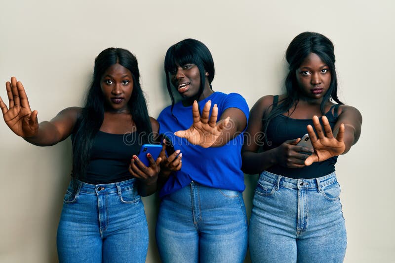Three Young African American Friends Using Smartphone Doing Stop ...