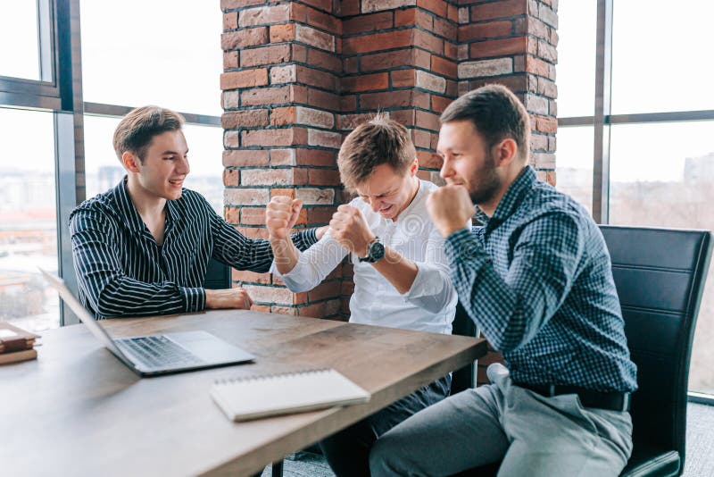 Joyful Colleagues Celebrating Their Successful Teamwork on a Laptop ...