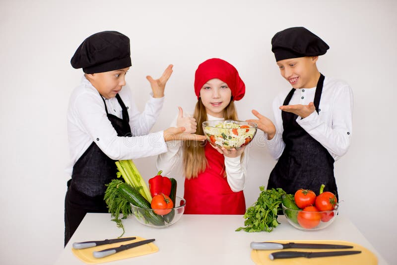 Three Young Chefs Evaluate a Salad Isolated Stock Image - Image of cook ...