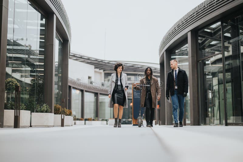 Three Young, Diverse Business Professionals Walking Together Outside a ...