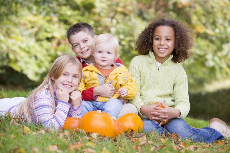 Three Young Friends with Baby and Pumpkins Stock Photo - Image of ...