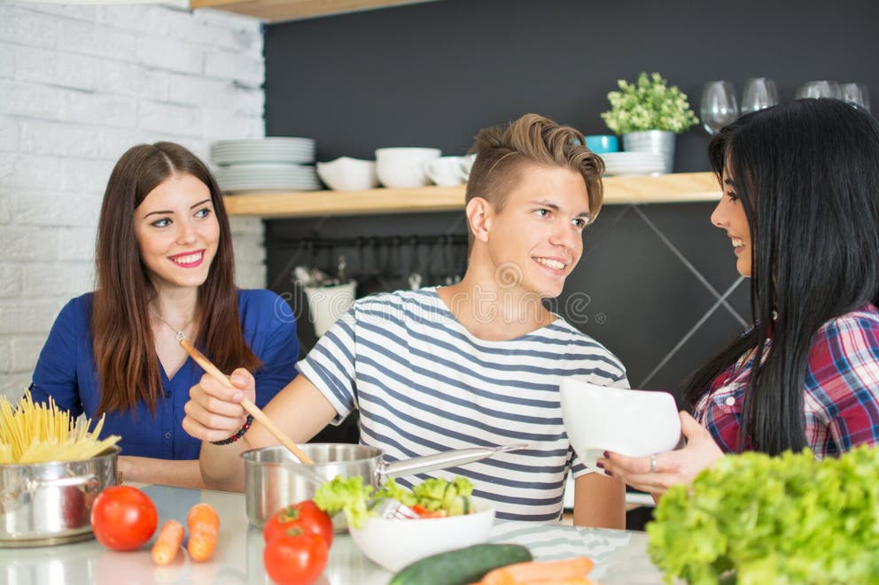 Three Young Friends Talking in the Kitchen. Stock Photo - Image of ...