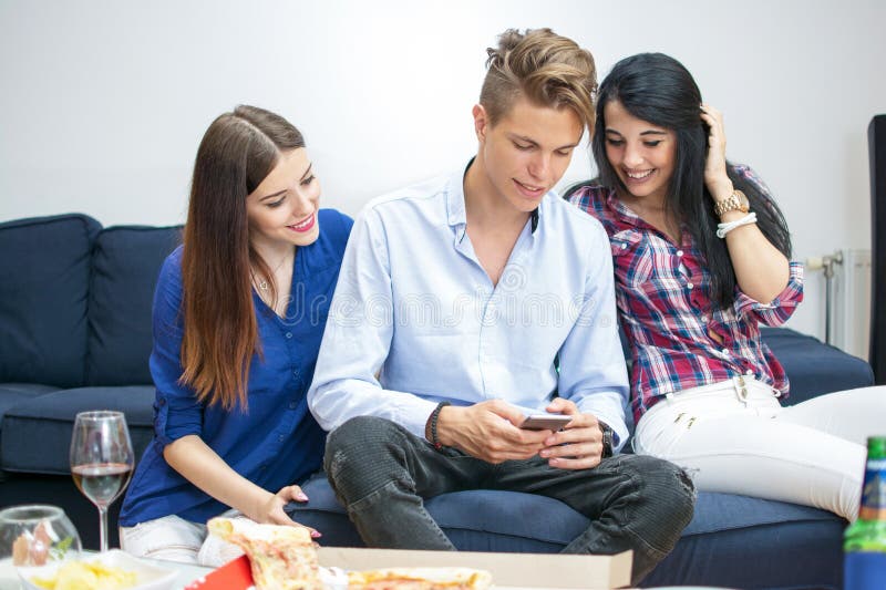 Three Young Friends Using Smartphone at Home. Stock Photo - Image of ...