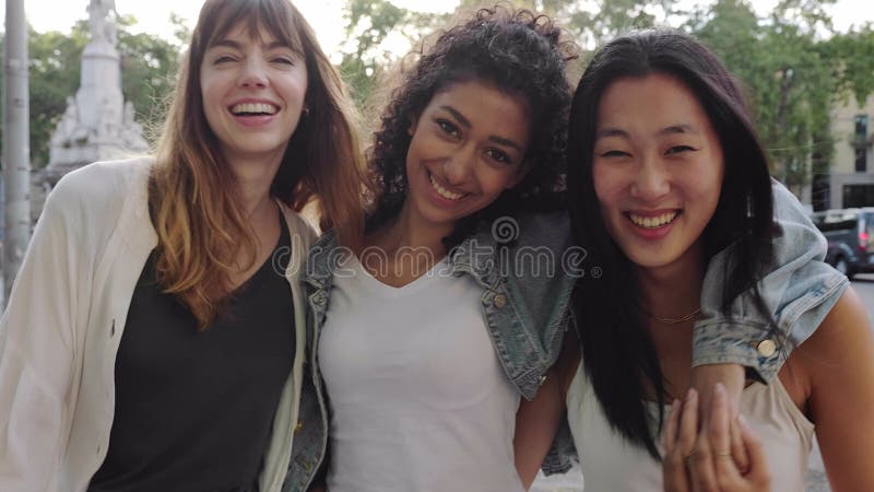 Three Happy Multiracial Young Friends Hanging Out while Walking in the ... Three Happy Multiracial Young Friends Hanging Out while Walking in the ...