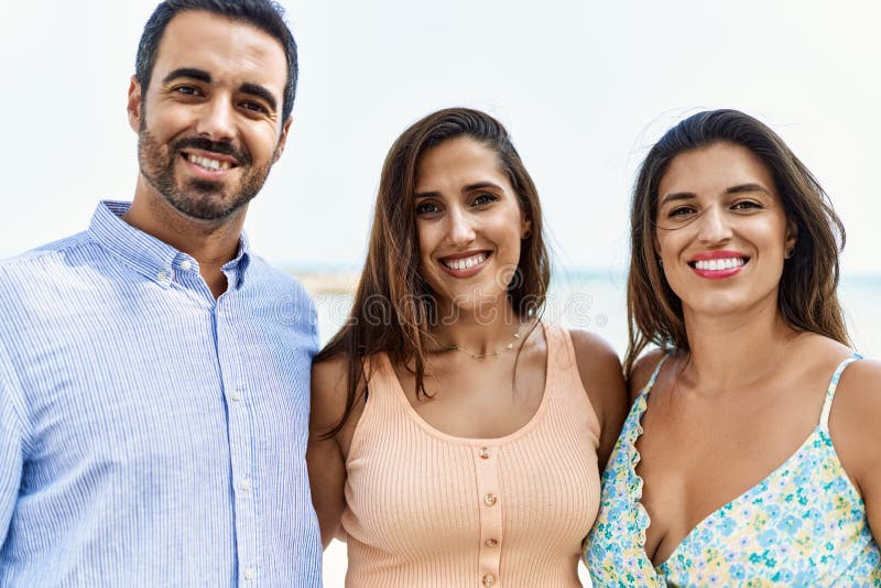 Three Young Hispanic Friends Smiling Happy and Hugging at the Beach ...