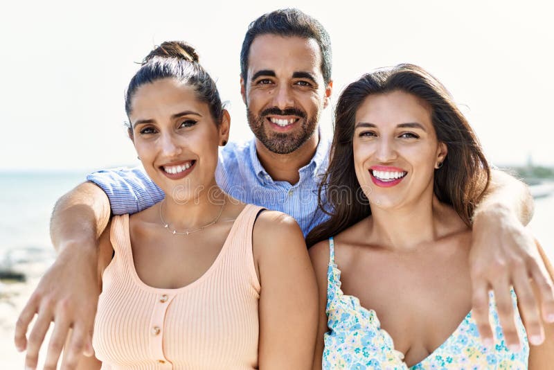 Three Young Hispanic Friends Smiling Happy and Hugging at the Beach ...