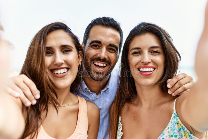 Three Young Hispanic Friends Smiling Happy and Hugging Make Selfie by ...