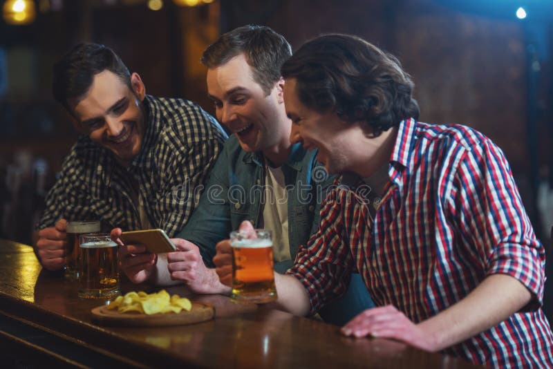 Men in pub stock photo. Image of friends, gadget, glass - 239501006