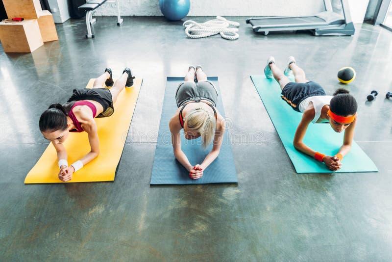 Three Young Multicultural Sportswomen Doing Plank Stock Photo - Image ...
