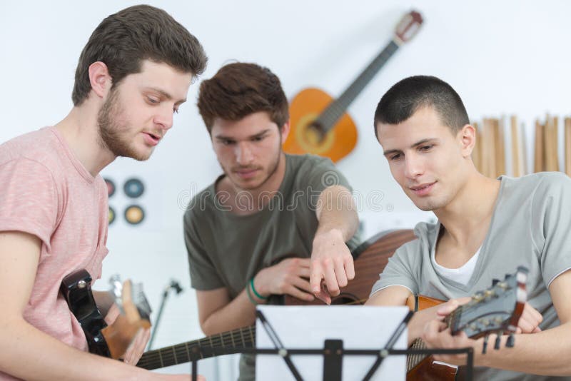 Three Young Musicians in Discussion Stock Image - Image of compose ...