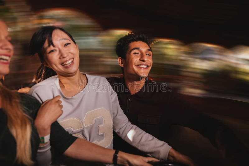 Three Young People on Amusement Park Ride. Stock Photo - Image of ...