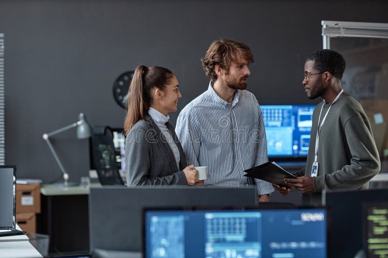 Three Young People Chatting Standing in Office Stock Image - Image of ...