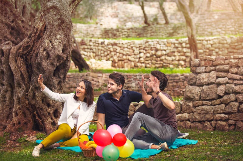 Three Young People Make Selfi Under the Olive Tree Stock Image - Image ...