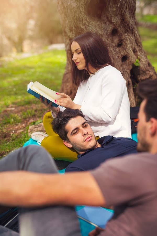 Three Young People on Picnic Under the Olive Trees Stock Image - Image ...