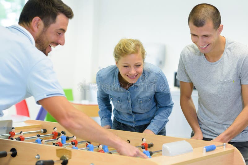 Three Young People Playing Table Football Stock Image - Image of happy ...