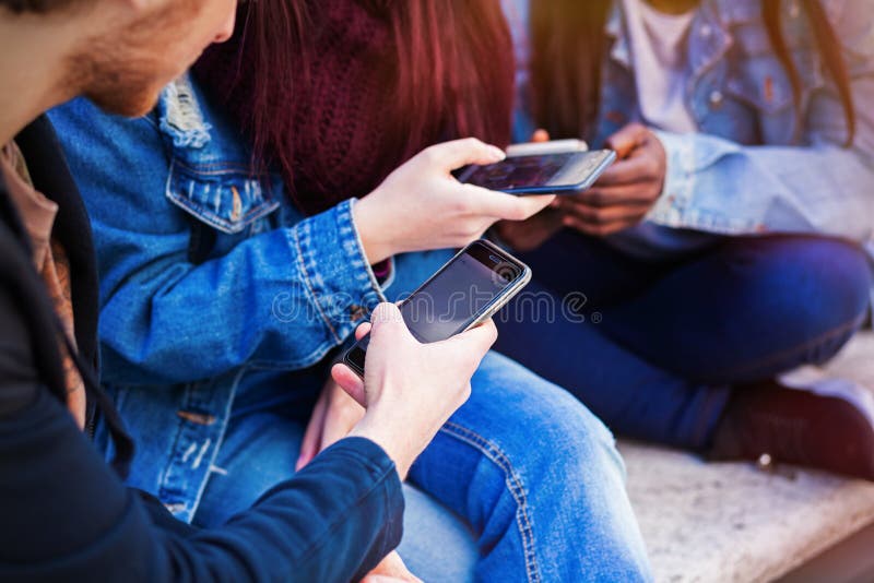 Three Young People Using Mobile Phone Stock Image - Image of friends ...
