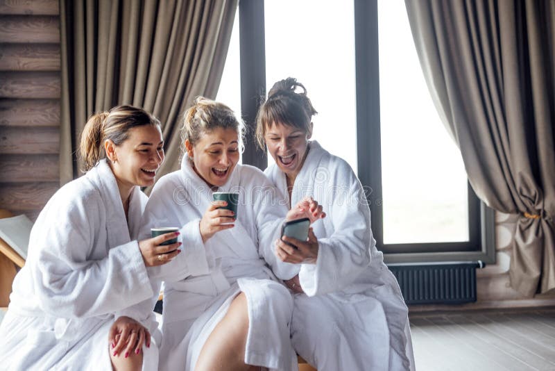 Three Young Smiling Women in White Bath Robes on Spa Procedure Stock ...