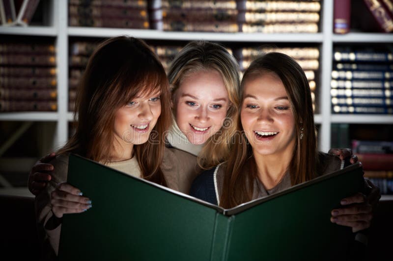 Young Students Reading Magic Book in Library Stock Photo - Image of ...