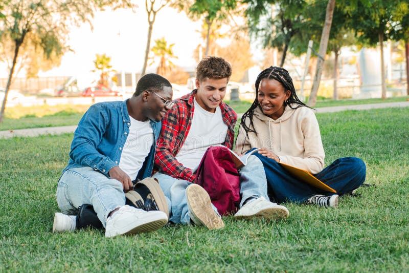 Two Students Sit on Lawn and Look in Laptop. Stock Photo - Image of ...