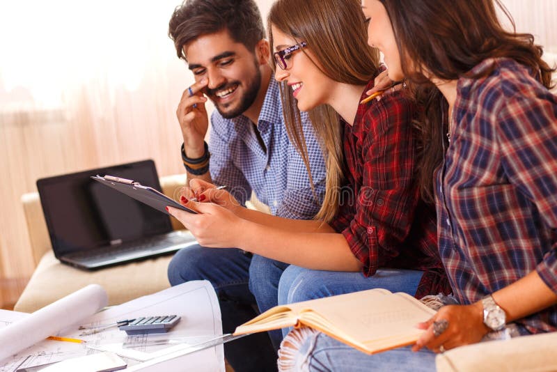 Three Young Students Working Together on a New Project. Stock Image ...