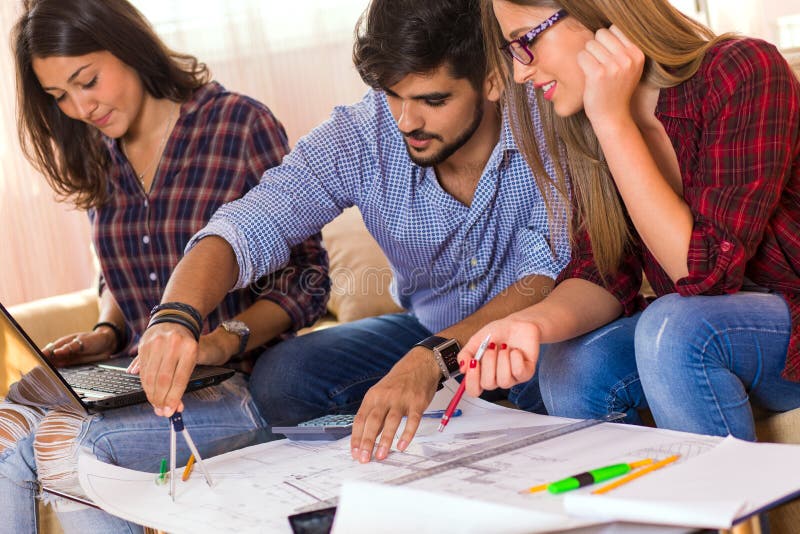 Three Young Students Working Together on a New Project. Stock Photo ...