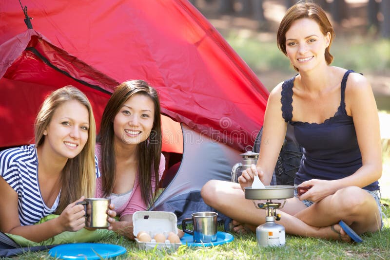 Three Young Women Cooking on Camping Stove Outside Tent Stock Image ...