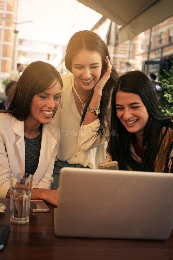 Three Young Women Having Conversation in Cafe. Stock Image - Image of ...