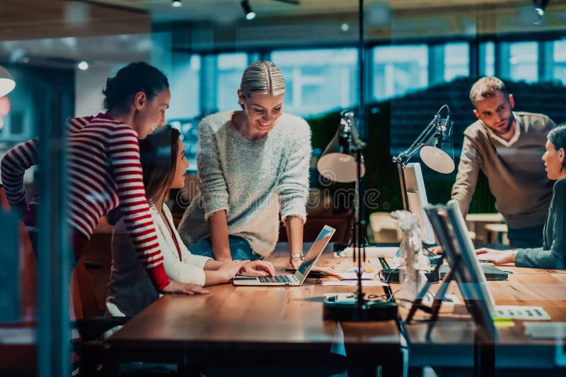 Three Young Women in a Modern Office Solve a Problem Together while ...