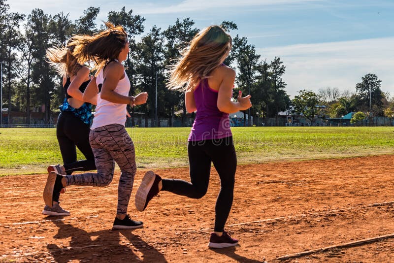 Three Young Women Running on the Running Track Stock Image - Image of ...