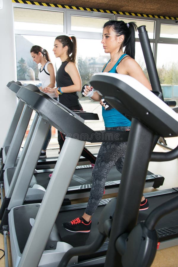 Three Young Women Running on Treadmill in Gym Stock Image - Image of ...