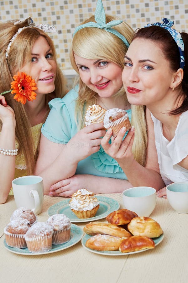 Three Young Women Sit and Eat Baked Sweets at Stock Photo - Image of ...