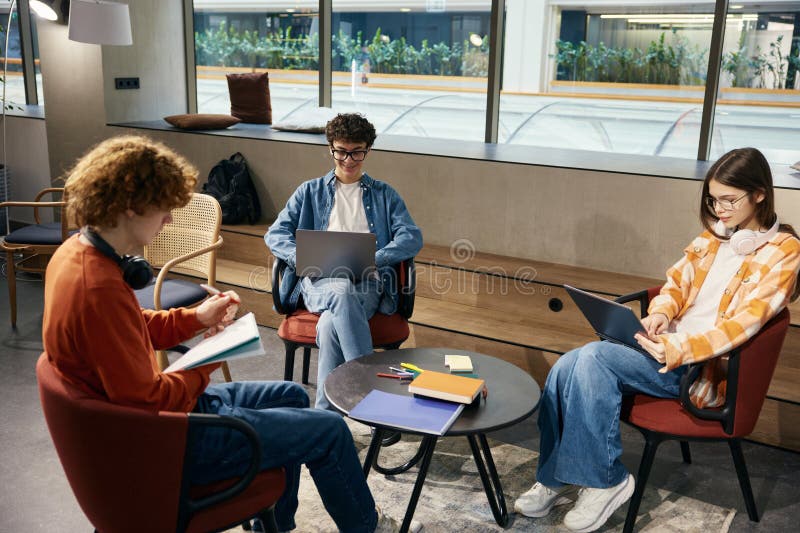 Three Young Workers Making Money Online Using Their Laptops in Modern ...