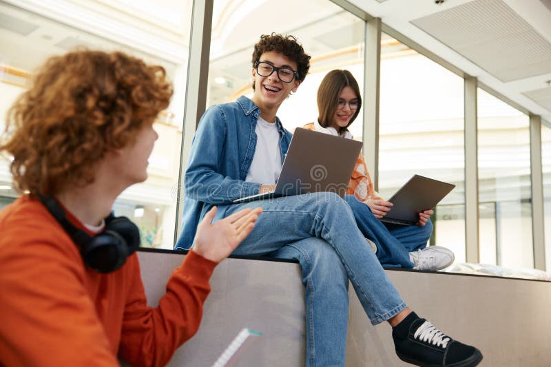 Three Young Workers Making Money Online Using Their Laptops in Modern ...