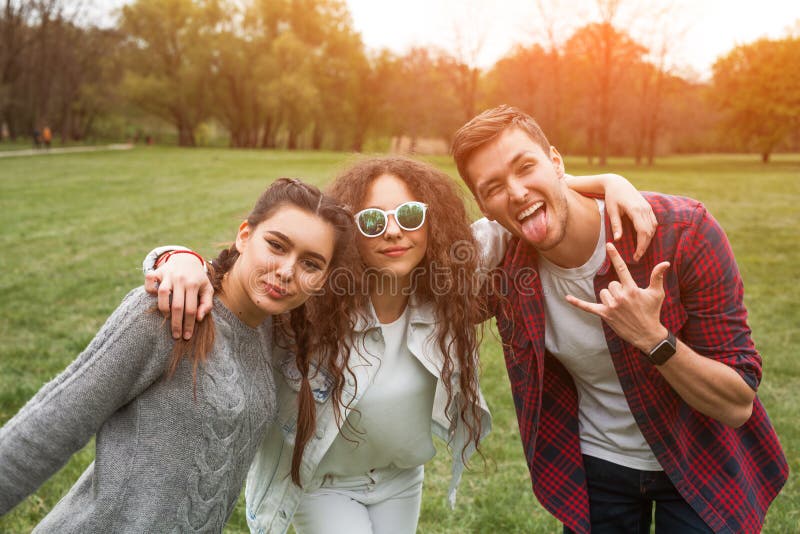 Three Youngster Posing in Park Stock Image - Image of laughing, symbol ...
