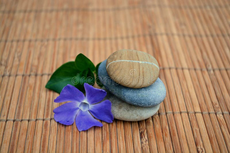 Three Zen Stones with Flower on Bamboo Reed Background Stock Photo ...