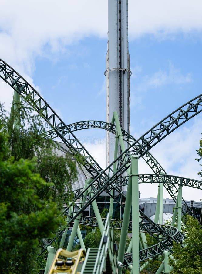 Thrilling Roller Coaster with Green Tracks and Yellow Car on Loop ...