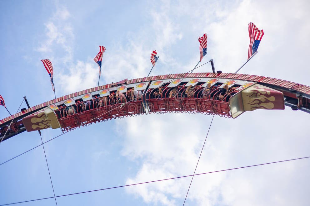 Thrilling Roller Coaster Loop with Flags Editorial Photo - Image of ...