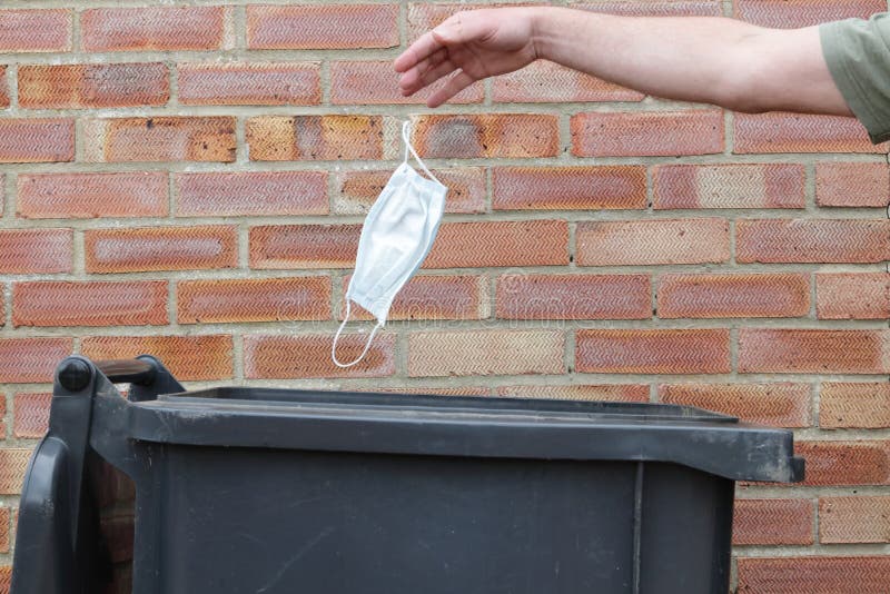 Throwing Face Mask into a Bin Stock Photo - Image of virus, infectious ...