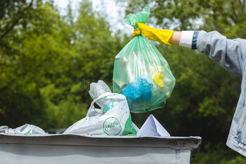 Throwing Garbage into a Trash Can. Close-up of a Hand Holding a Garbage ...