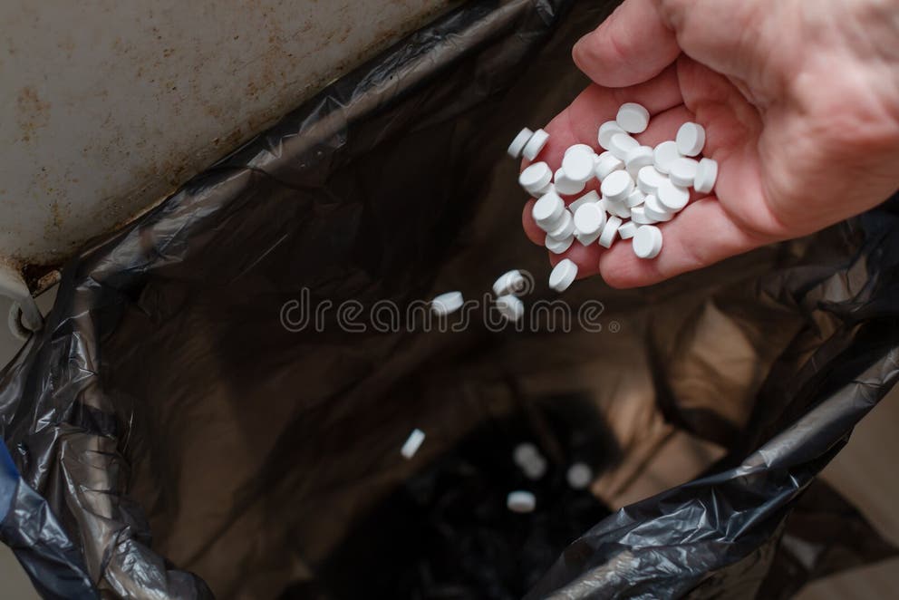 Throwing Pills into the Garbage - Illegal Disposal Stock Photo - Image ...
