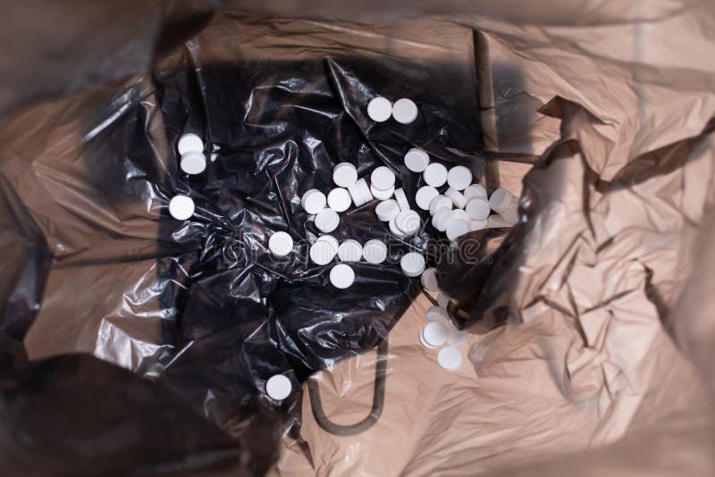 Throwing Pills into the Garbage - Illegal Disposal Stock Photo - Image ...