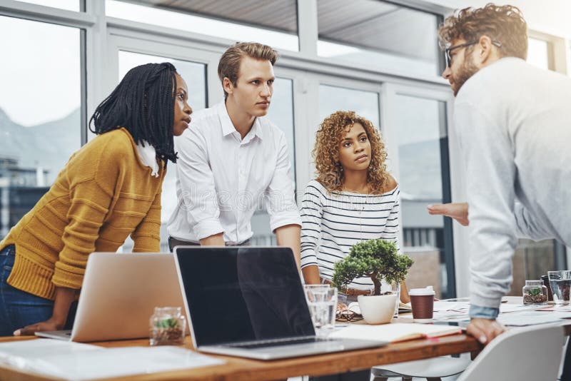 Throwing Some Ideas Around. a Group of Businesspeople Having a Brainstorming Session. Stock ...