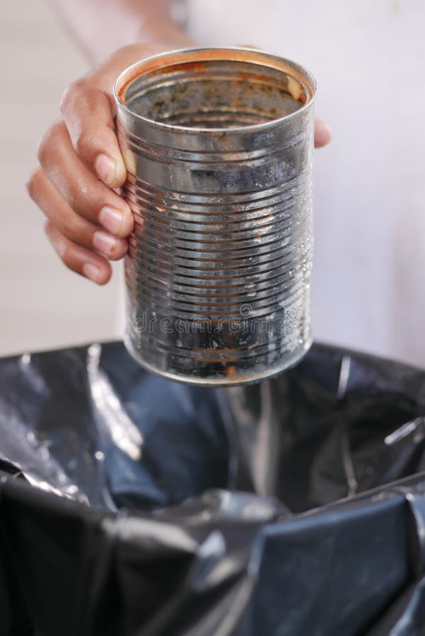 Throwing Tin Container in a Garbage Bin Stock Image - Image of silver ...