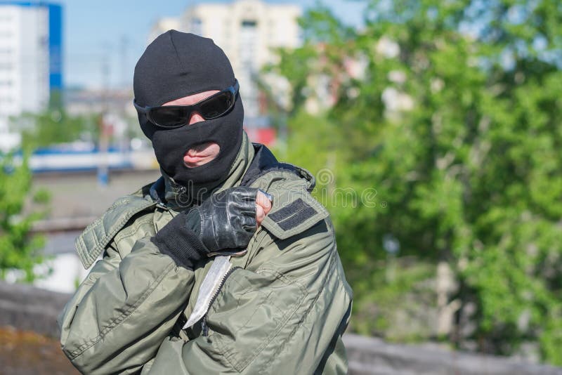 A Thug in Black Glasses and a Balaclava with a Knife is Plotting ...