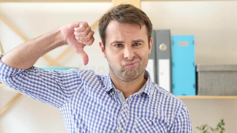 Thumbs Down by Man Sitting in Office Stock Image - Image of office ...